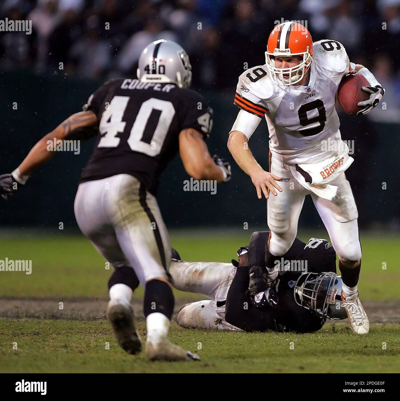 Cleveland Browns quarterback Charlie Frye (9) is wrapped up by Oakland ...