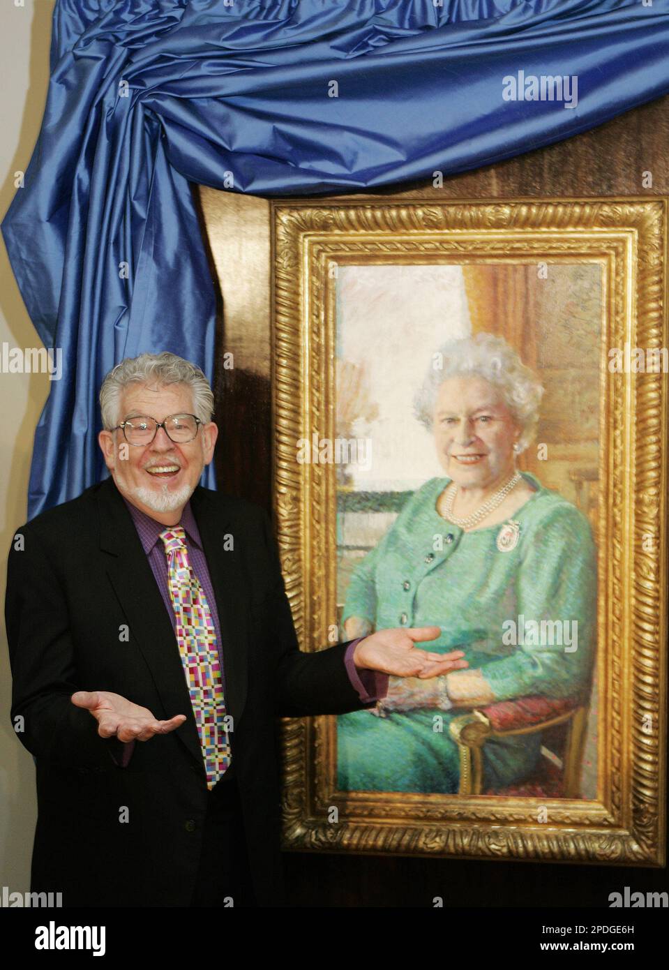 Artist Rolf Harris stands with his portrait of Britain's Queen ...