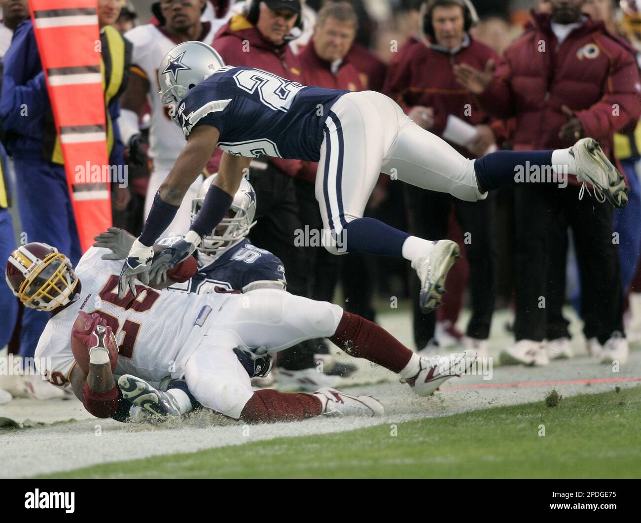 Dallas Cowboys safety Keith Davis, top, helps knock Washington Redskins ...