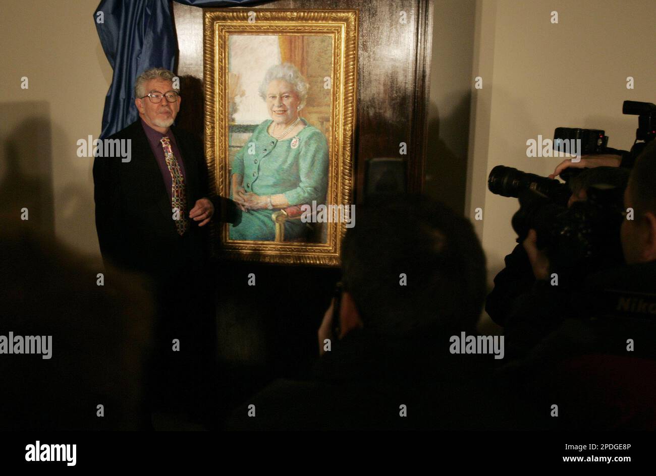 Artist Rolf Harris stands with his portrait of Britain's Queen ...