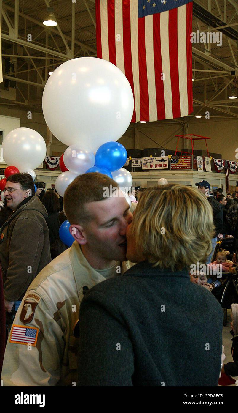 Spc. Chris Neal of East Greenwich, R.I., kisses his wife Lauren after ...