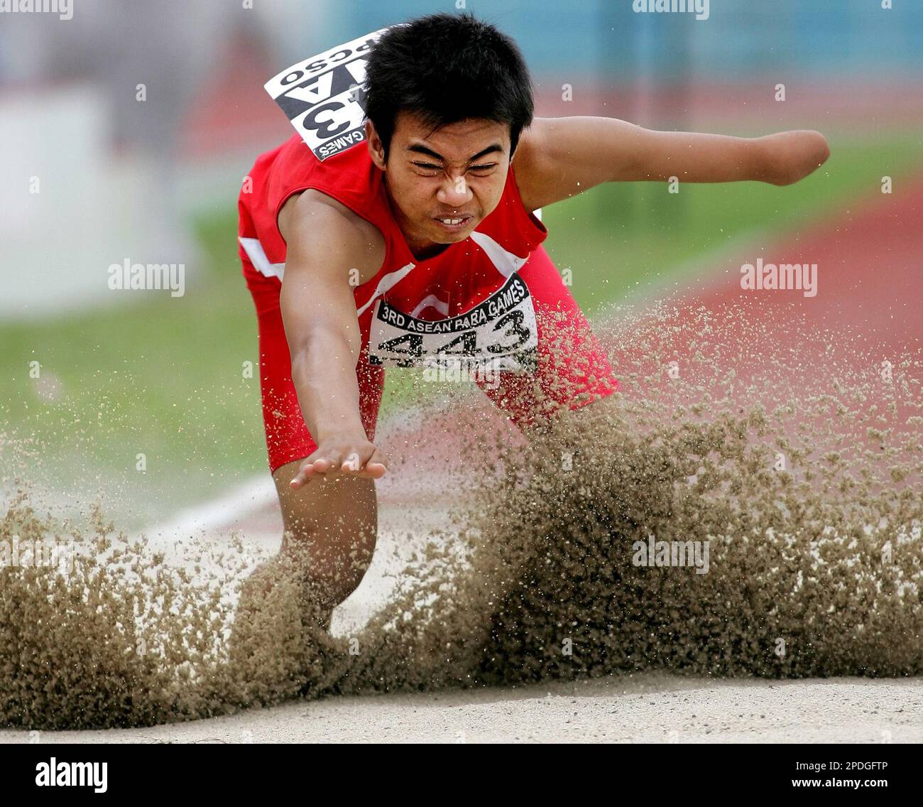 Indonesian Setiyo Budi Hartanto lands during the men's long jump final ...
