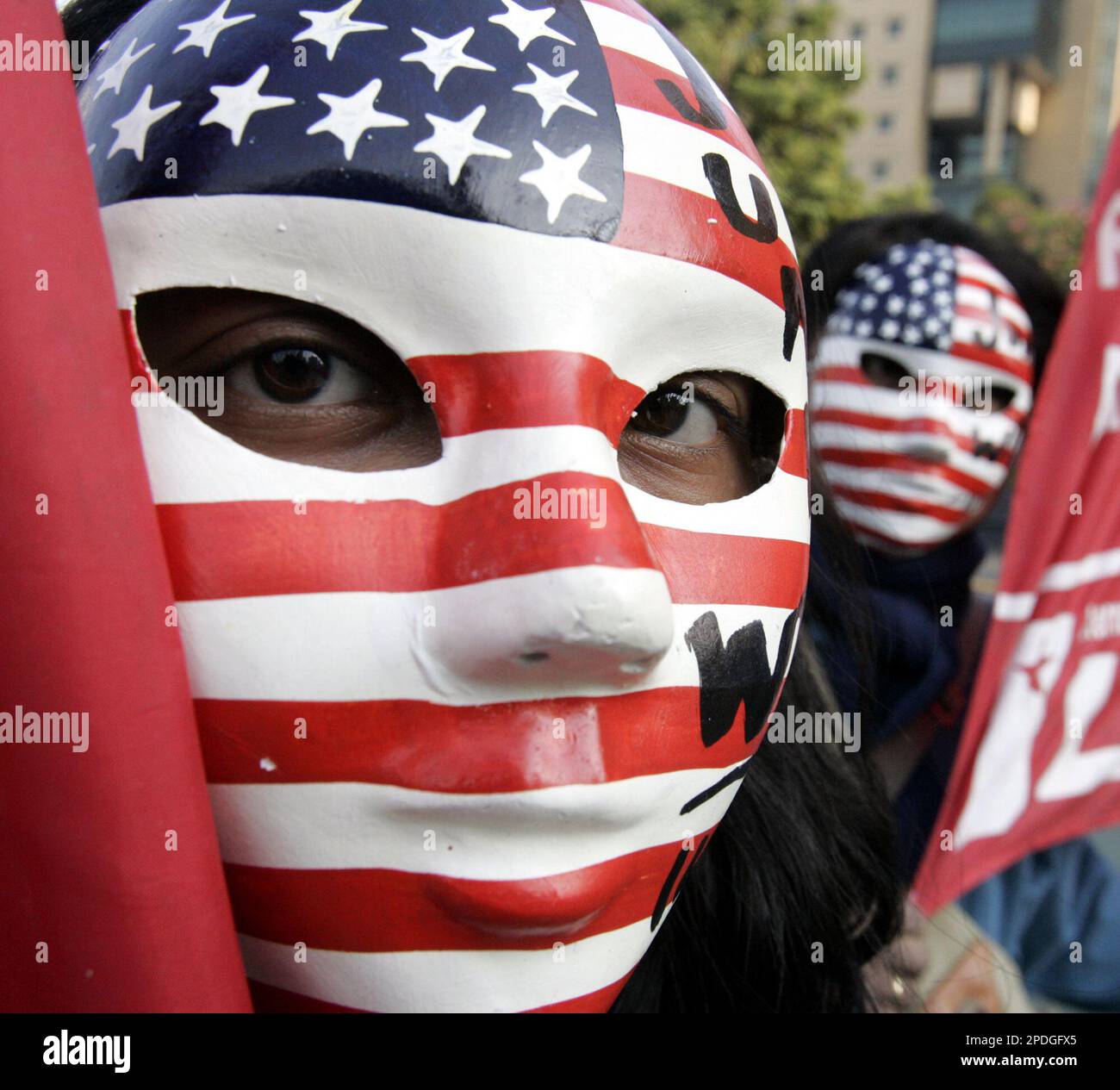 Anti-WTO protesters wear anti-U.S. masks as they march in downtown Hong ...