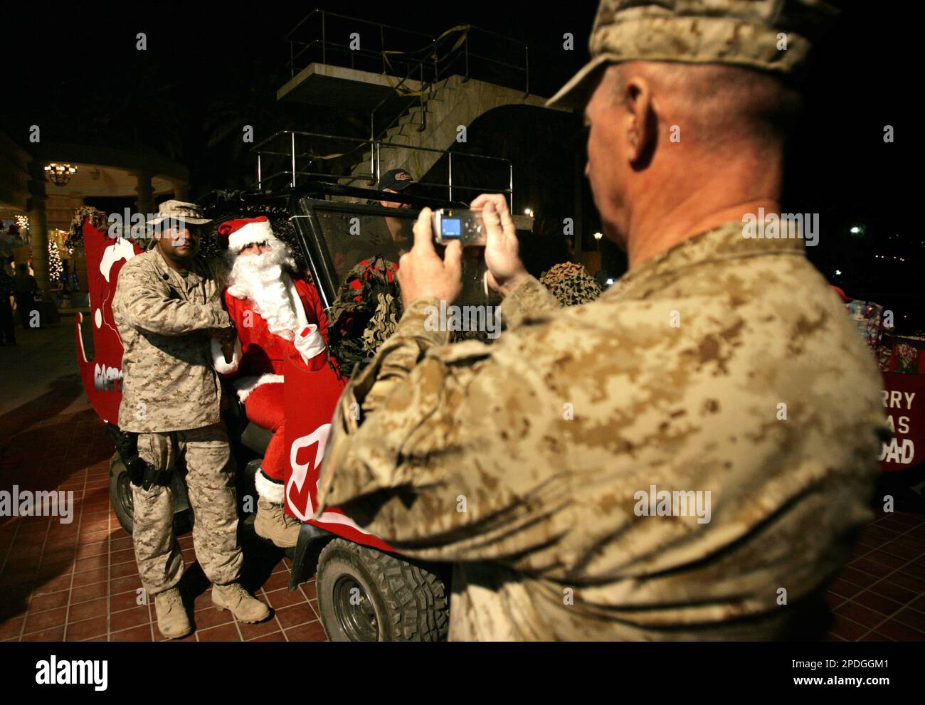 U.S. Marine Corps Master Gunnery Sergeant Barcia Peter, left, stands ...