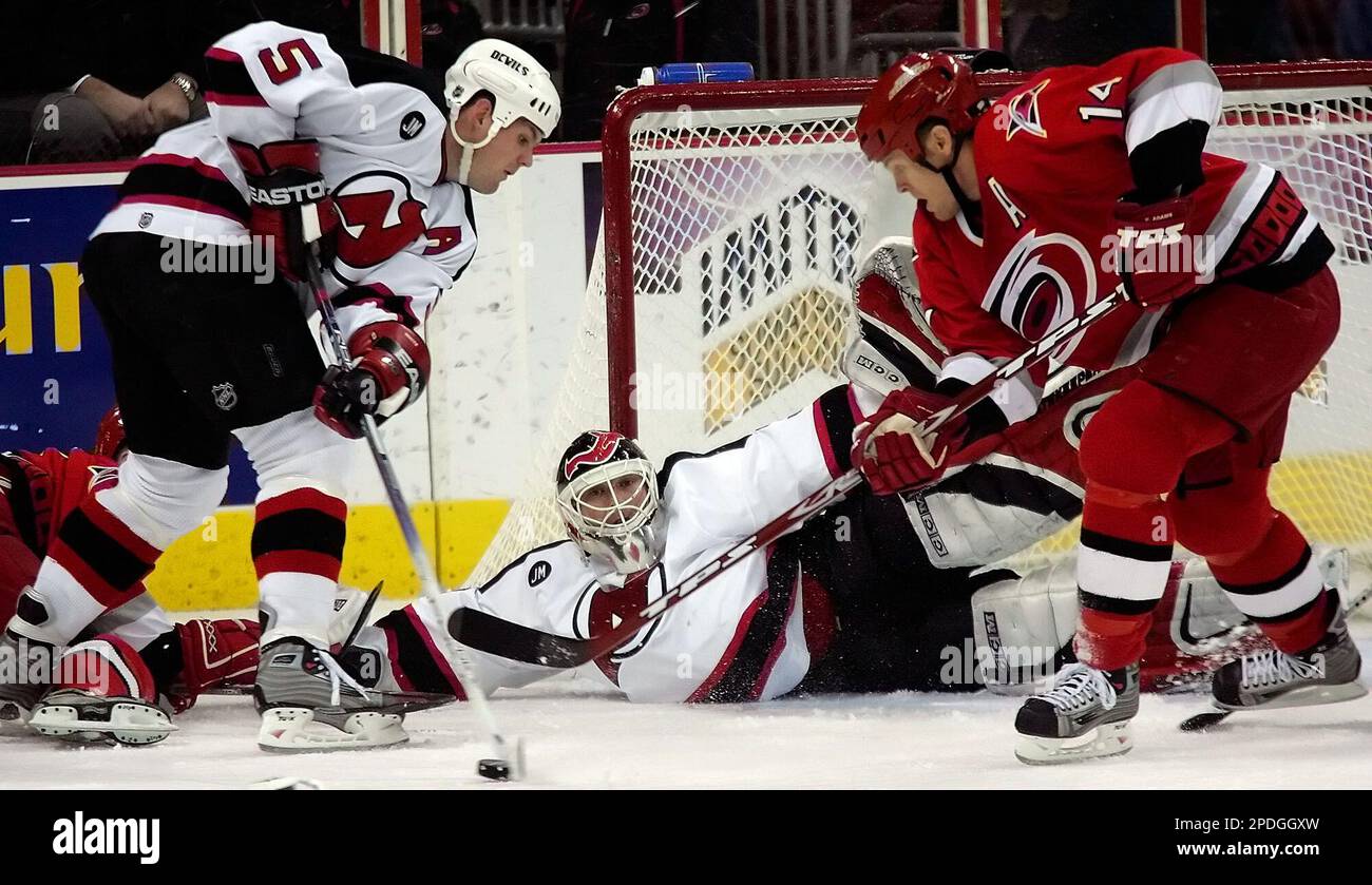 Carolina Hurricanes Kevyn Admam, right, battles New Jersey Devil's ...