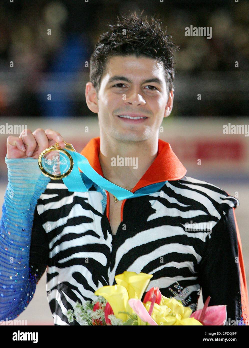 Men's free skating gold medalist Stephane Lambiel of Switzerland shows his medal during an ...