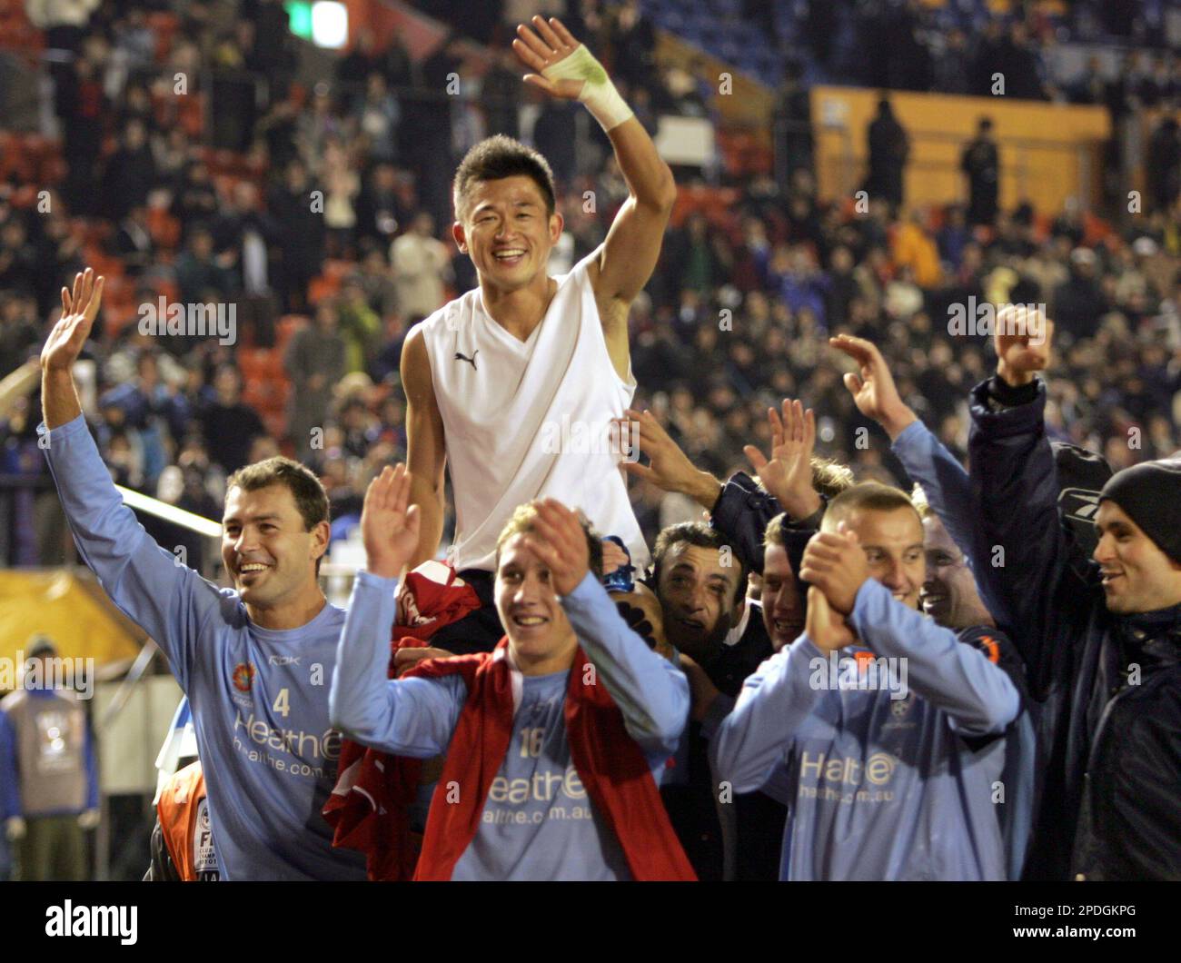Sydney FC's Japanese striker Kazu Miura is lifted up by his teammates ...