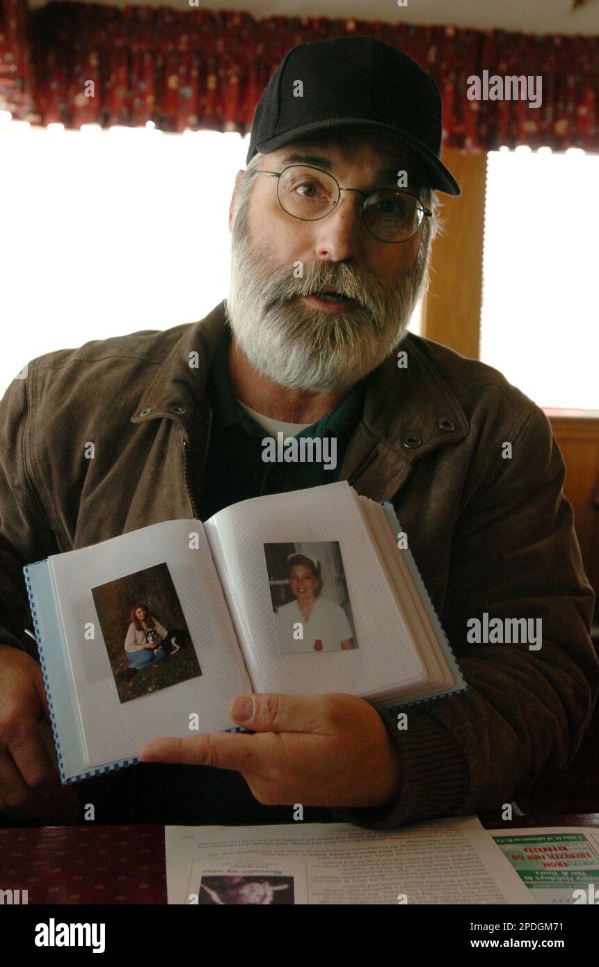 Mike Dyabelko holds a family album of photographs of his daughter ...