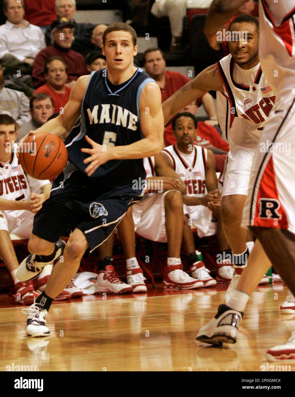 Maine's Jon Sheets drives past Rutgers' Jaron Griffin during the first ...