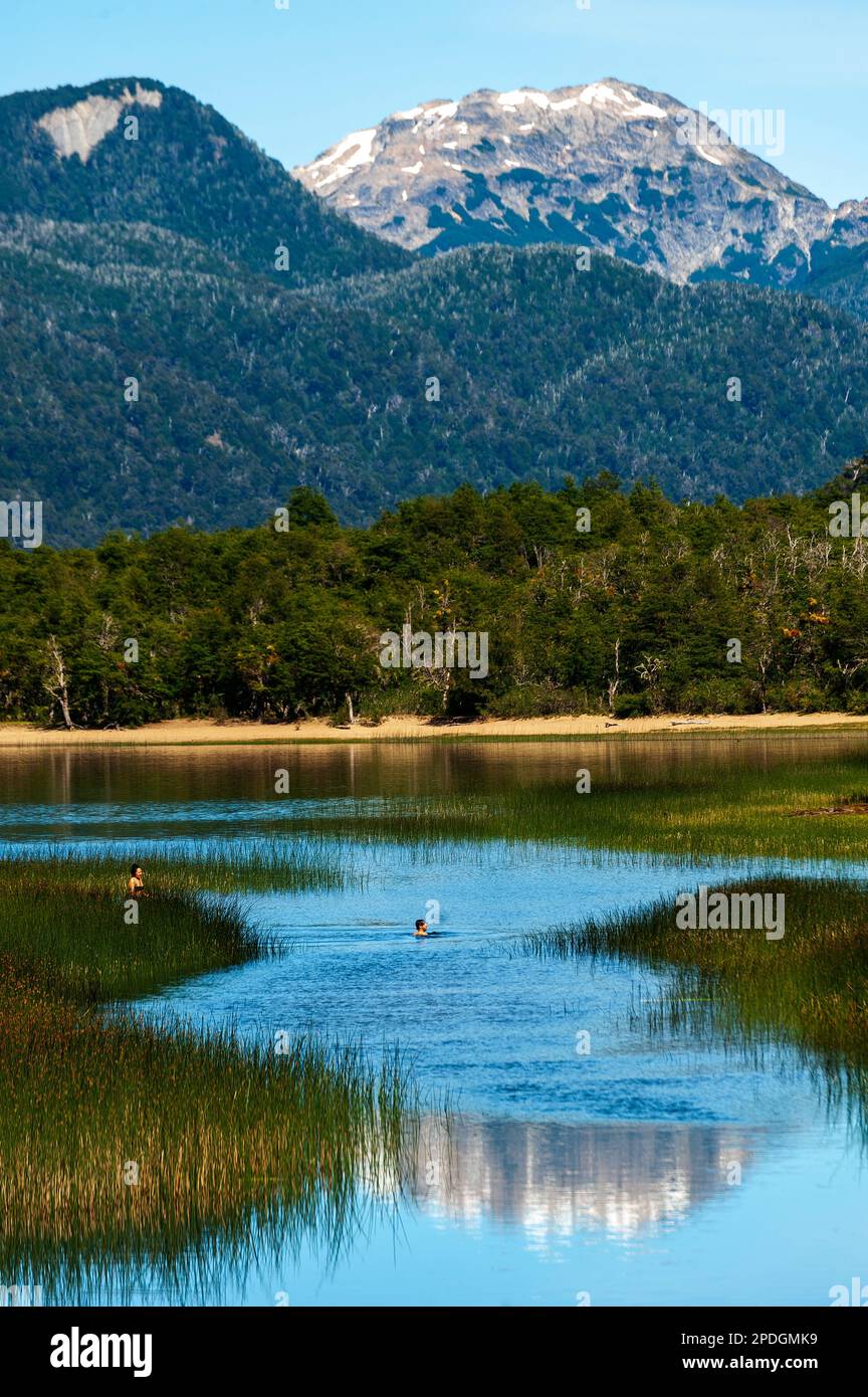 Campground on the shores of Lake Villarino on Ruta 40, snowy peaks in ...