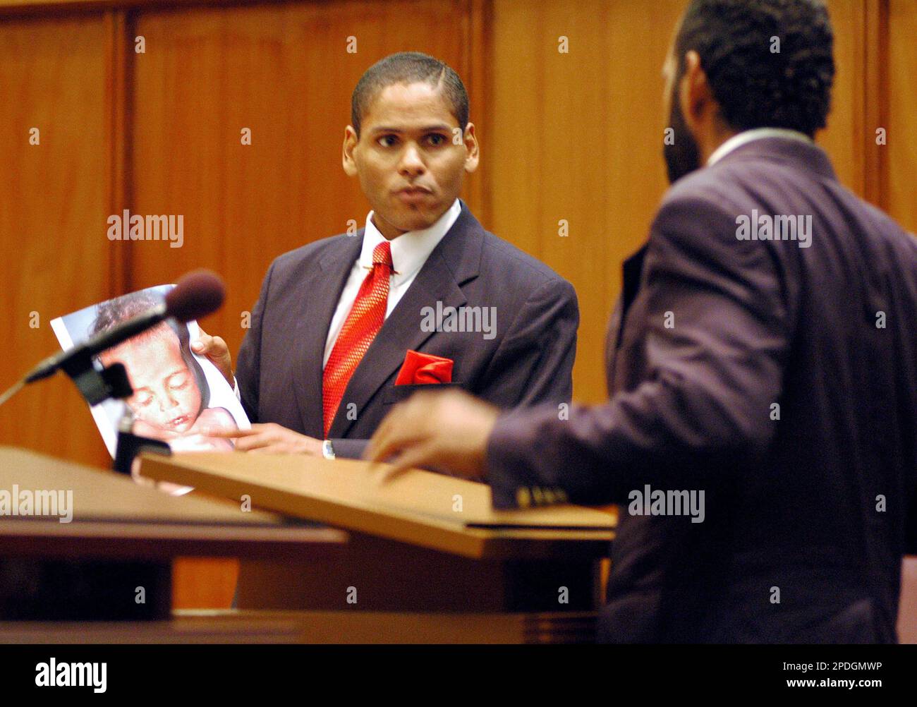 Prosecutor Herbert E. Walker III, left, shows an image of Woyah ...