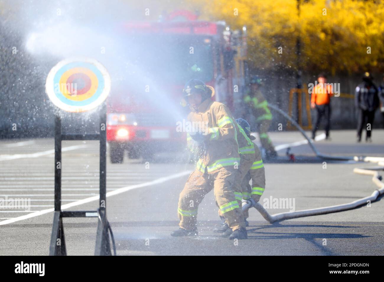 15th Mar, 2023. Firefighters' contest Firefighters use a fire hose to ...