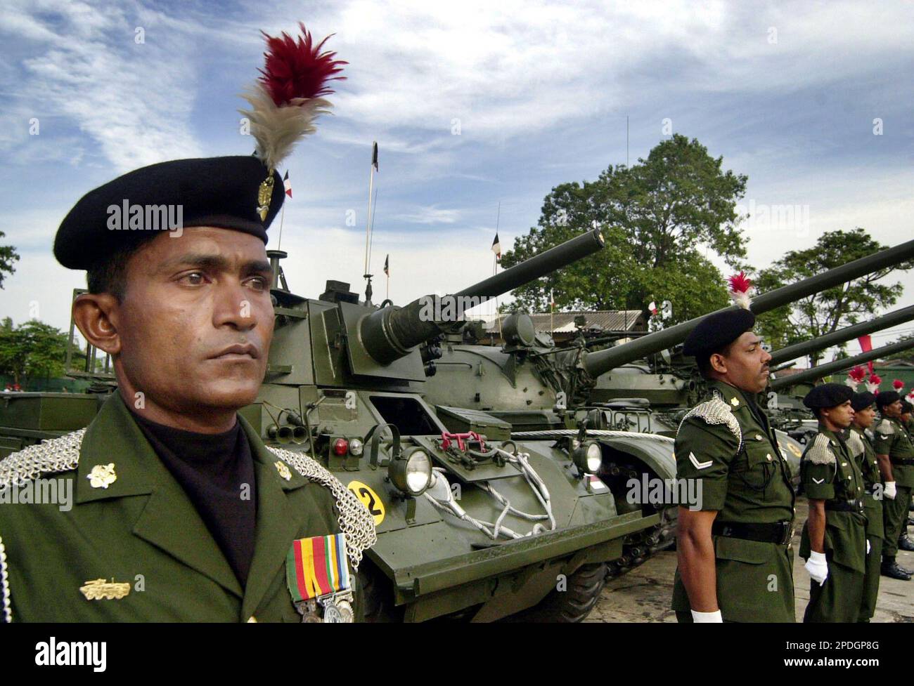 Soldiers of Sri Lanka Army's Armed Corps unit stand in front of armed tanks during a parade held ...