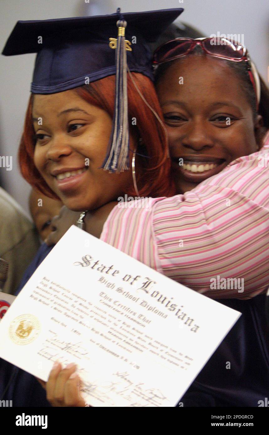 High School graduate Constance Harrison, left, is hugged by her sister ...