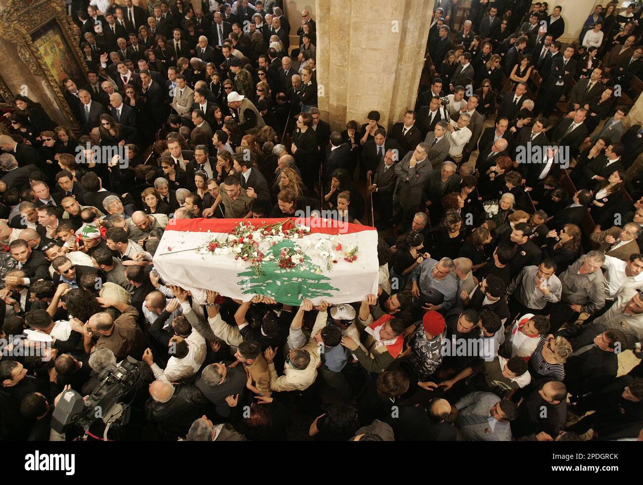 Lebanese mourners carry the coffin of slain anti-Syrian journalist and ...