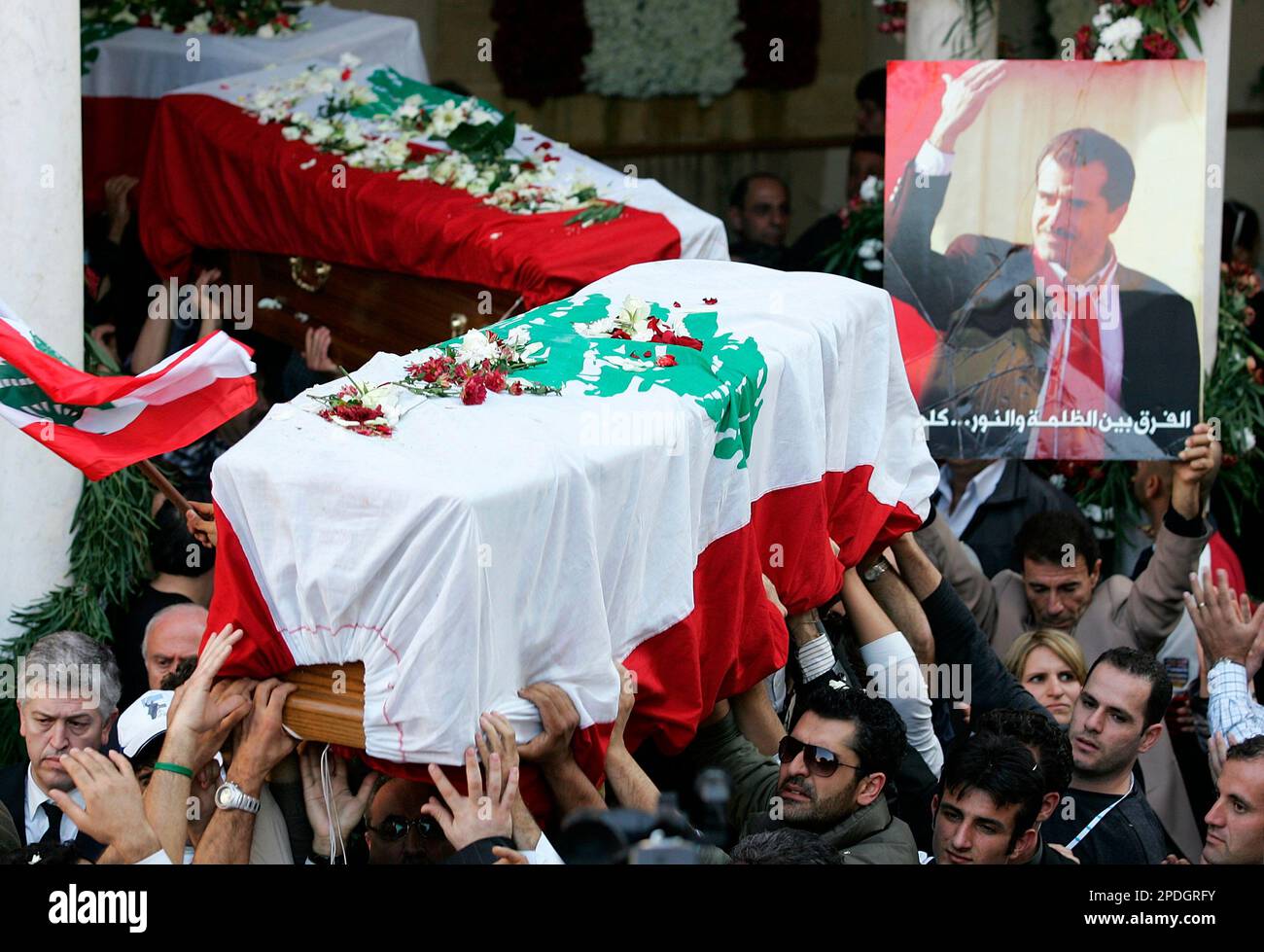 Lebanese mourners carry the coffins of slain anti-Syrian journalist and ...