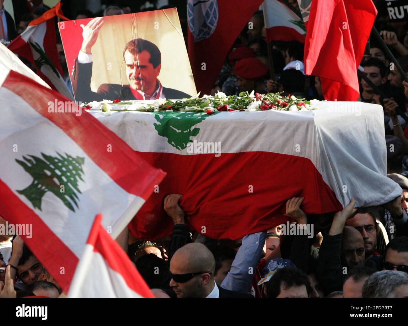 Lebanese mourners carry the coffin of slain anti-Syrian journalist and ...