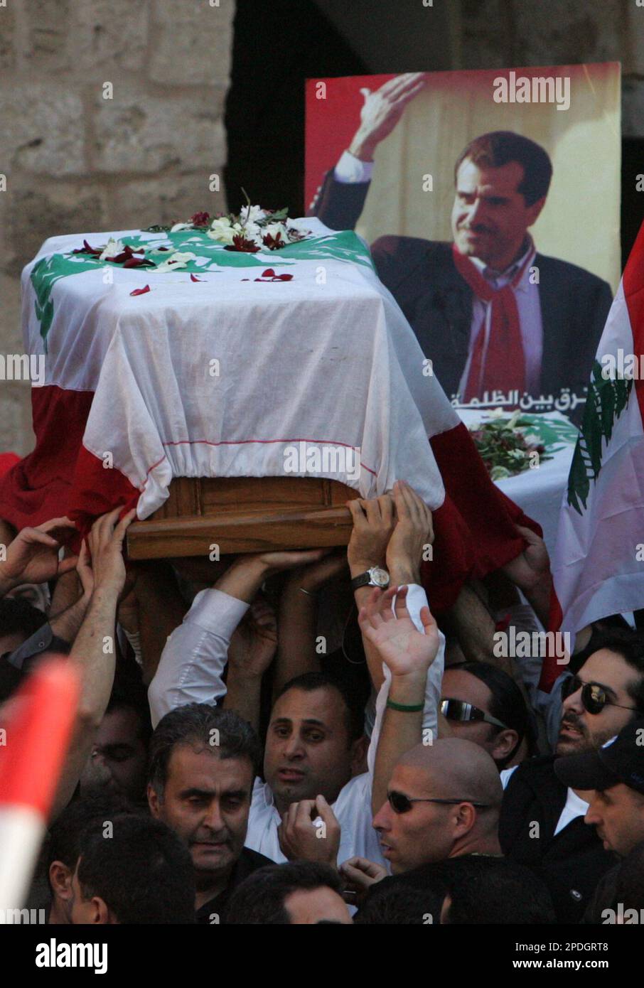 Lebanese mourners carry the coffin of slain anti-Syrian journalist and ...