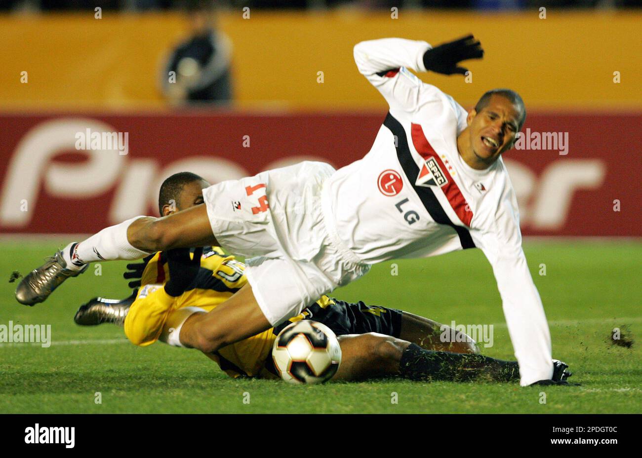 Brazil's Sao Paulo FC Aloisio falls down after collided with Redha ...