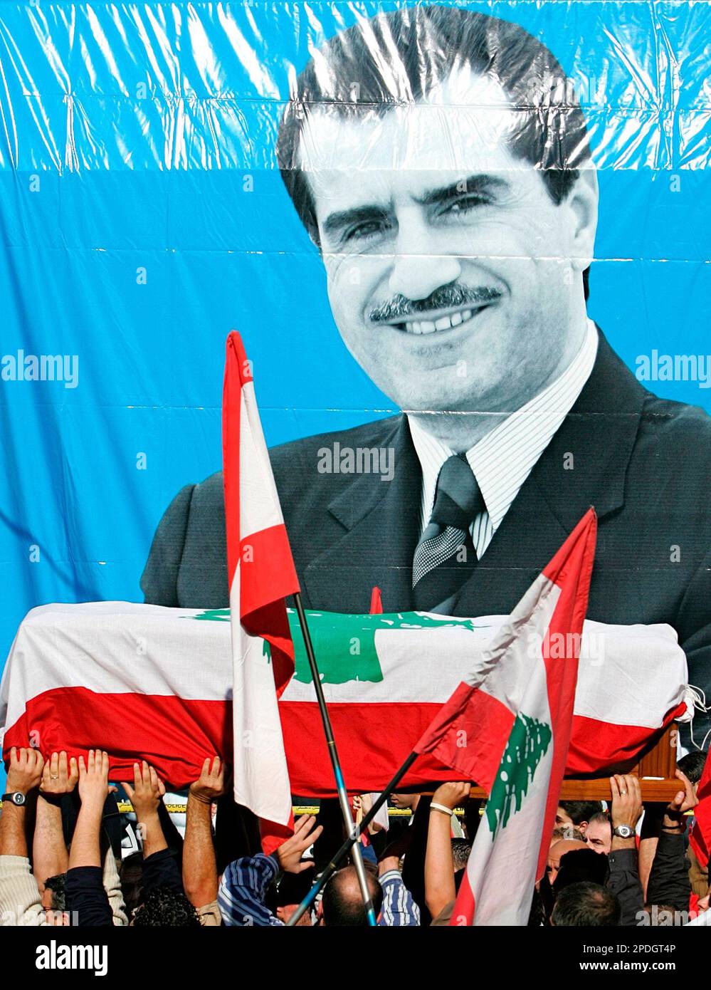 Lebanese mourners carry the coffin of slain anti-Syrian journalist and ...