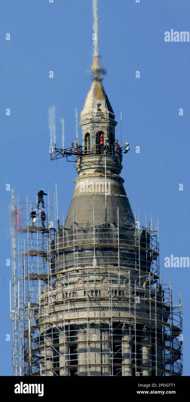 Workers build scaffolding near the top of Terminal Tower that rises 708 ...