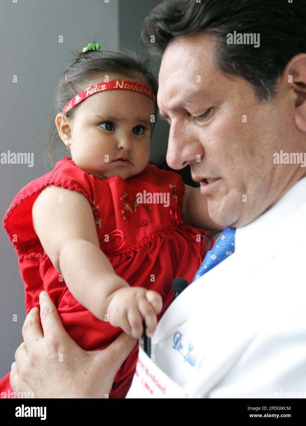 Milagros Cerron plays with Peruvian doctor Luis Rubio after a news ...