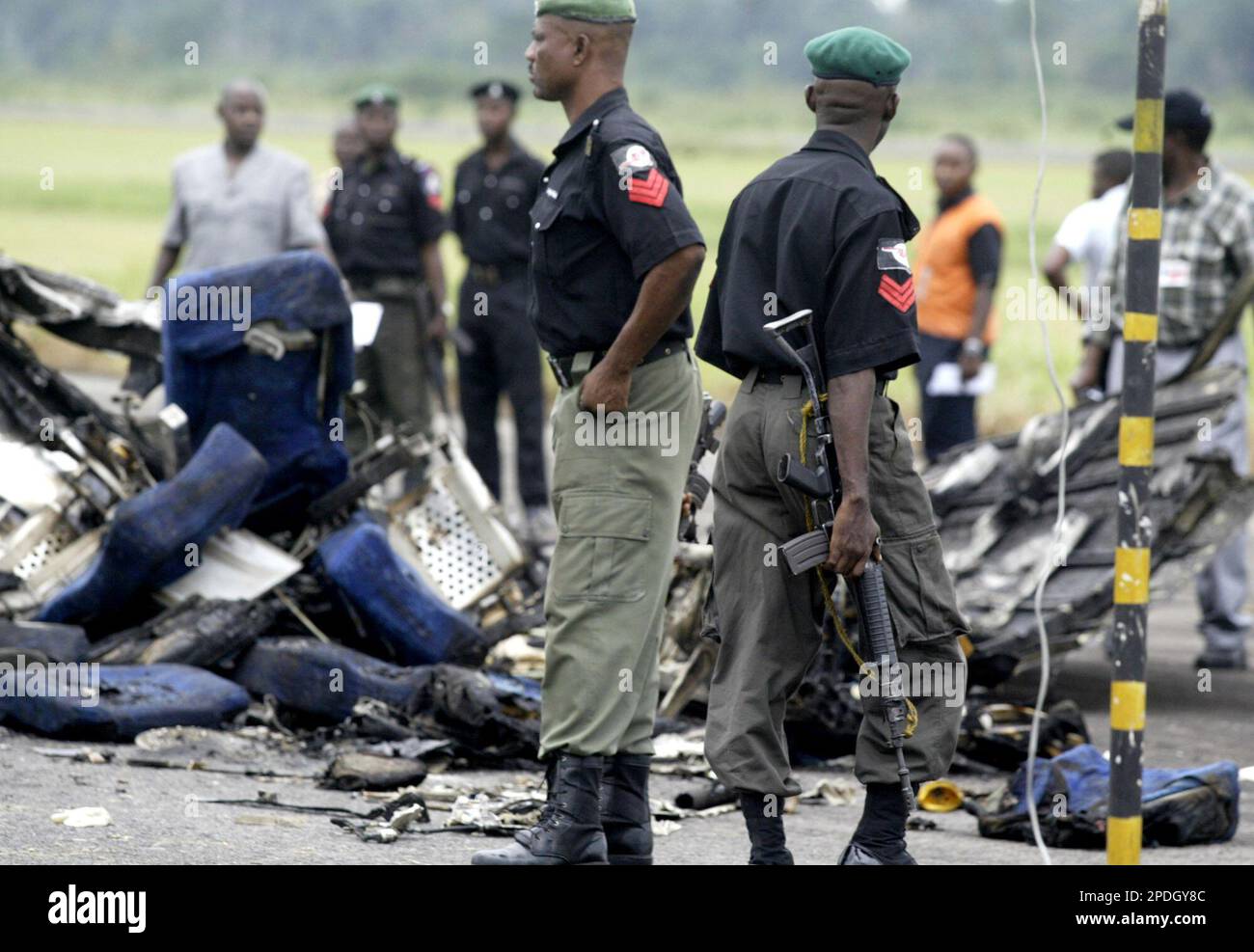 Police officers stand guard near the wreckage of the Sosoliso plane at ...