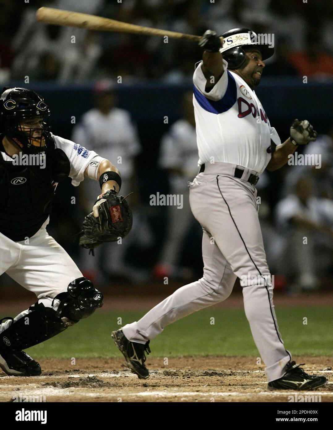 Dominican Republic's Luis Polonia, right, follows through for a 2-RBI ...