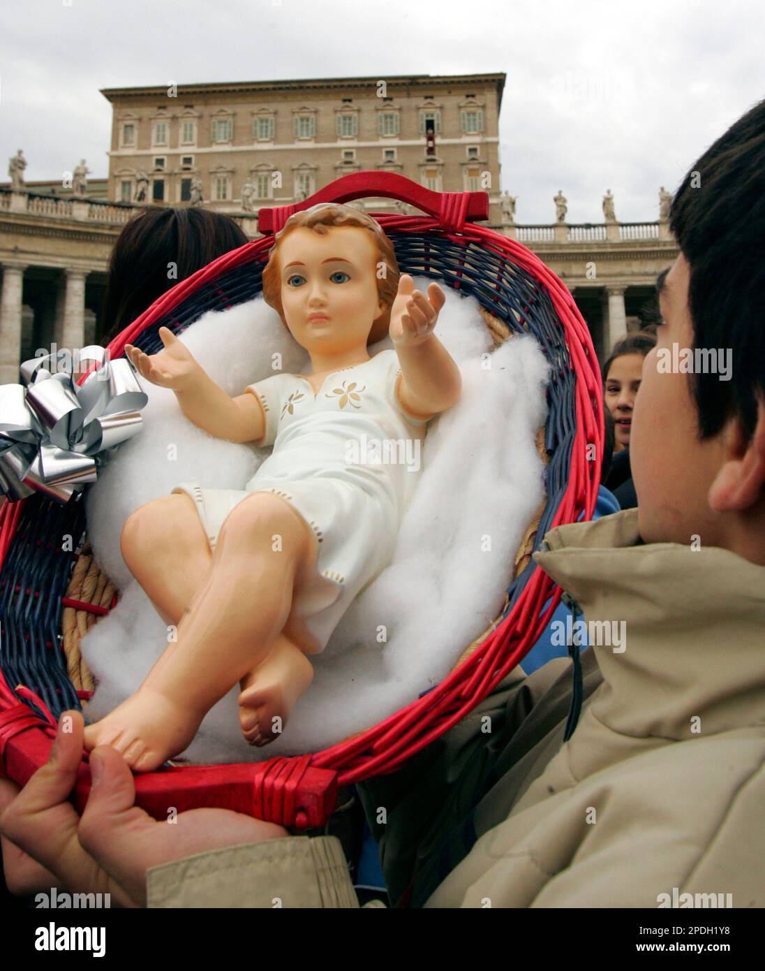 A boy displays a Nativity figure of baby Jesus for Pope Benedict XVI to ...