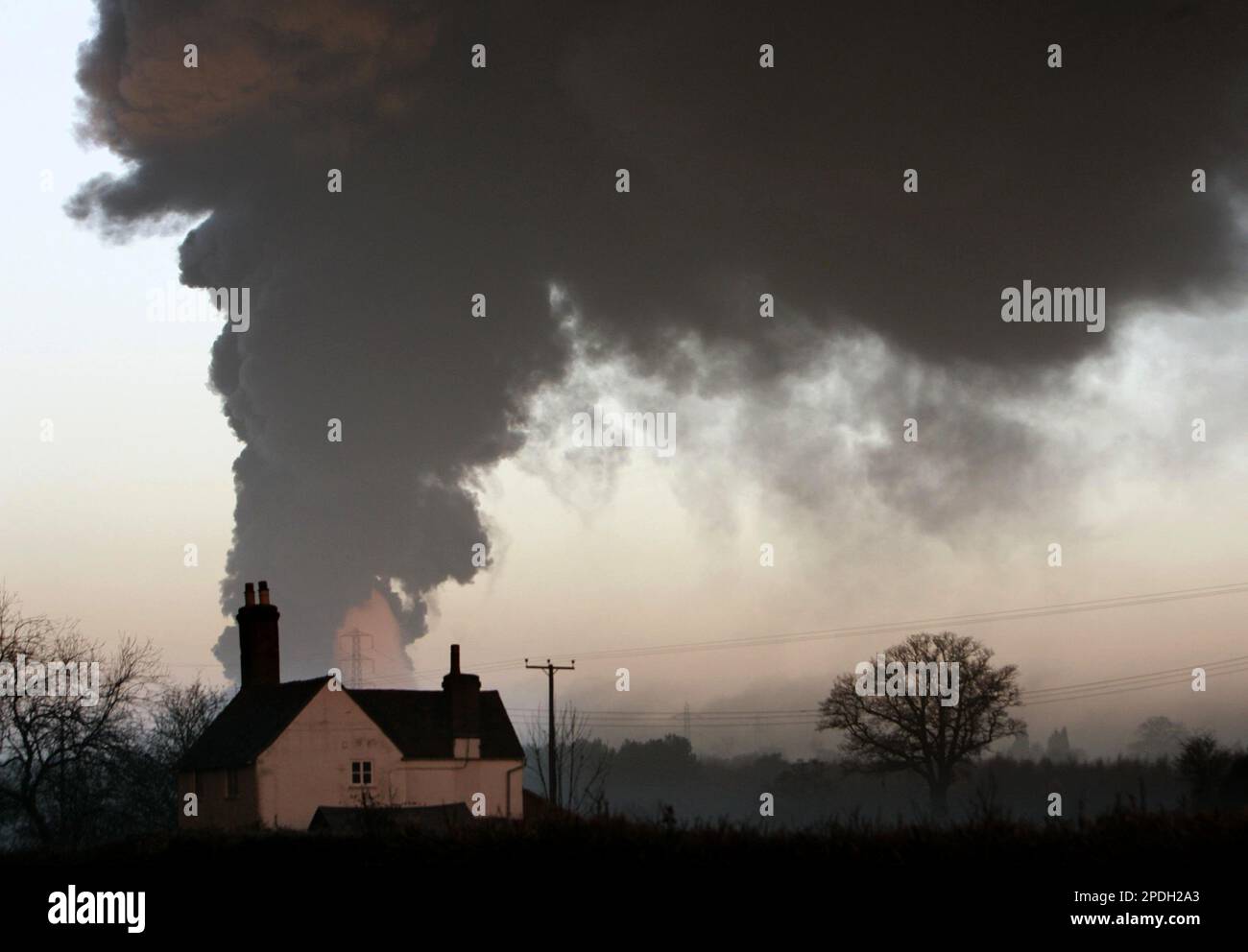A plume of smoke rises from Buncefield Oil Terminal, in Hemel Hempstead ...