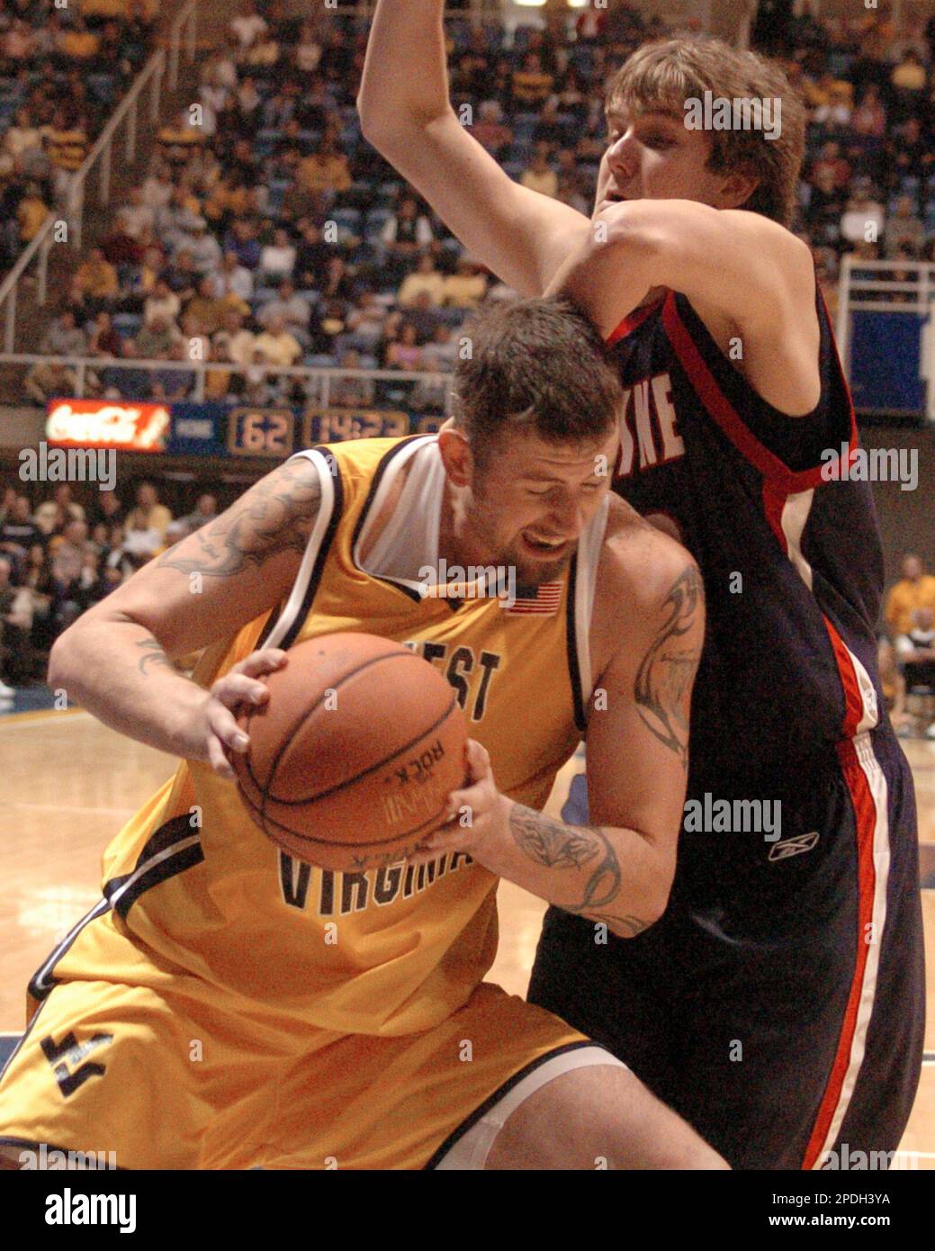 West Virginia University center Kevin Pittsnogle, left, drives past ...