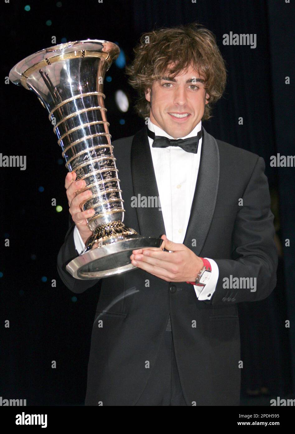 Spanish Formula One champion Fernando Alonso holds his trophy during ...