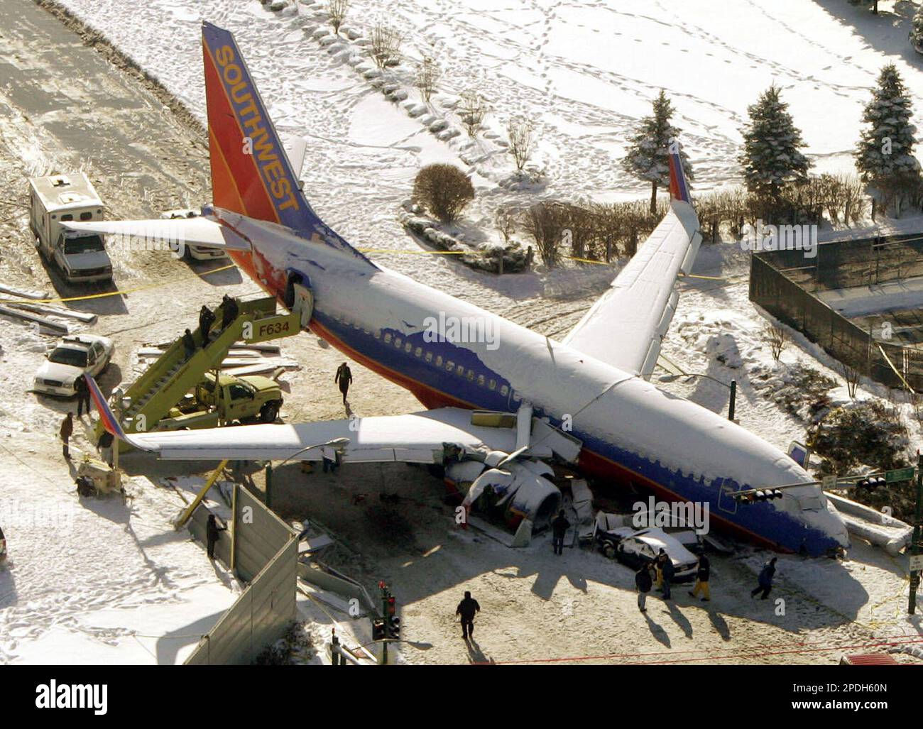 A Southwest Airlines Boeing 737 rests nose first in the intersection of ...