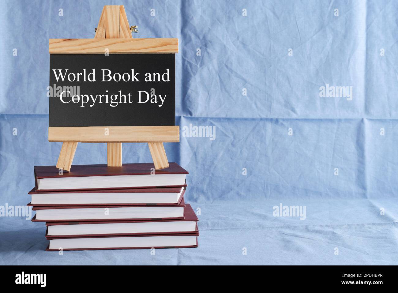 World Book and Copyright Day written on black board on stack of books ...