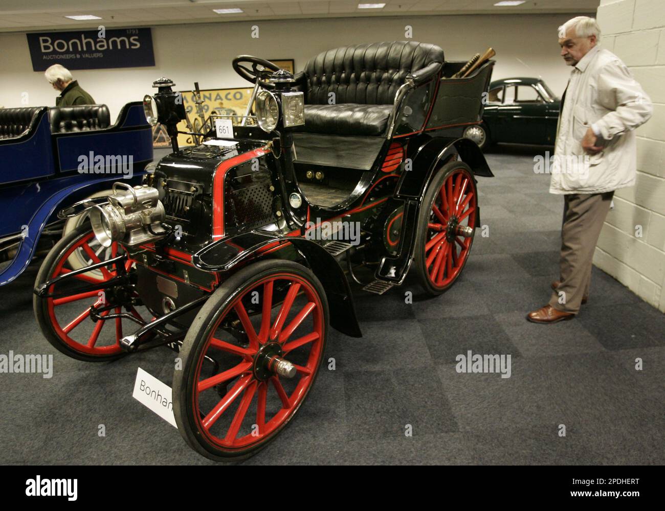 A man views a rare 6-hp MMC Charette Tonneau car built in 1900, prior ...