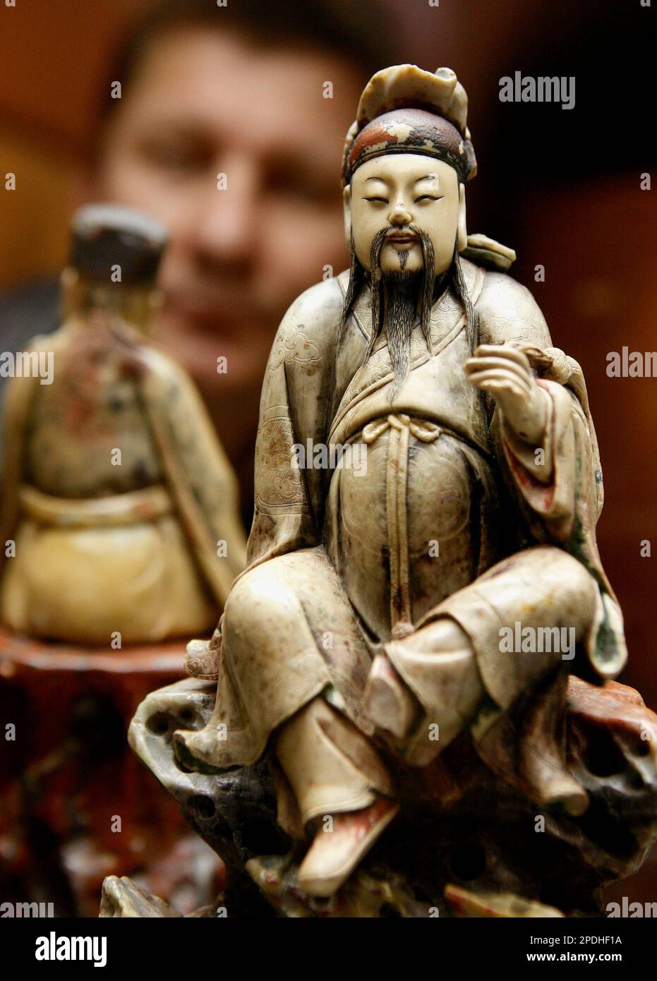 The figure 'seated daoist immortal Lue Dongbin on rock pedestal' made ...