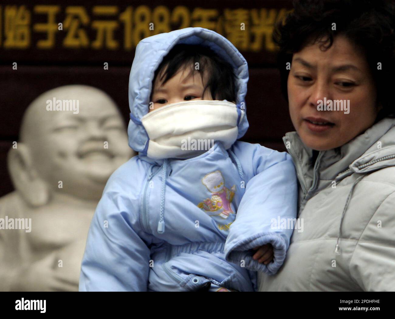 A child is heavily dressed against cold wind Monday Dec. 5, 2005 in ...