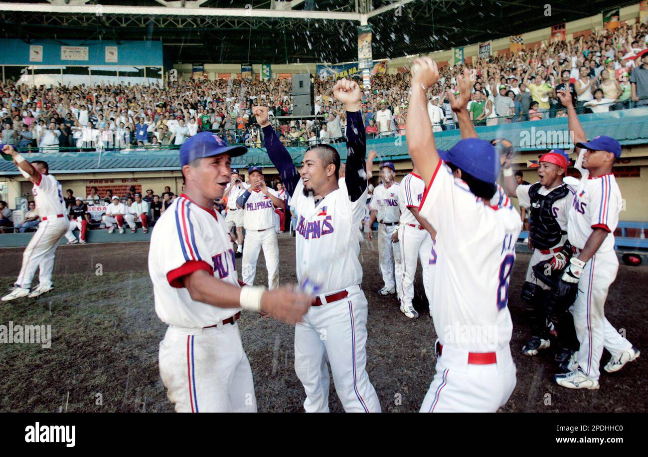 The Philippine baseball team celebrates their win over Thailand at ...