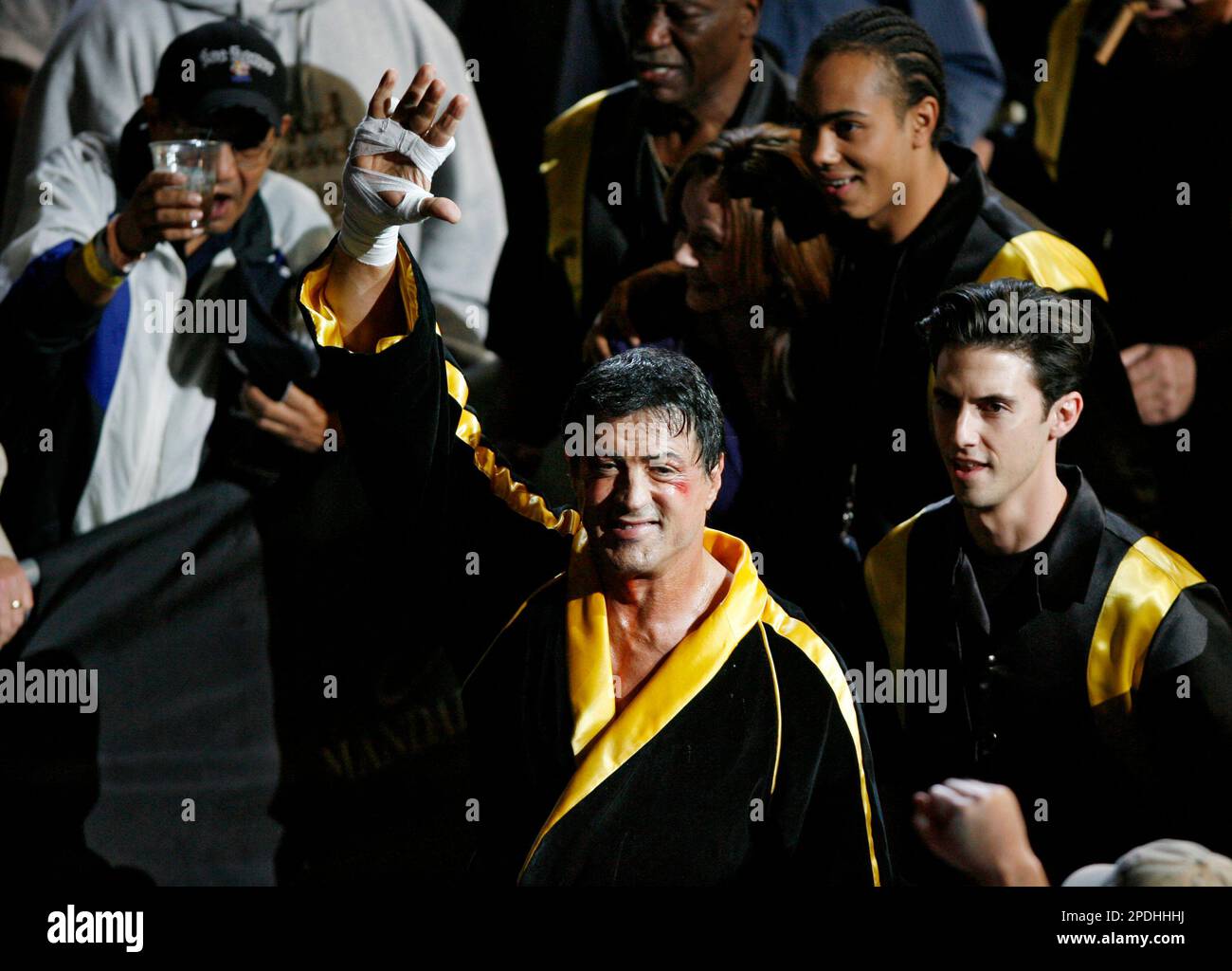 Fans cheer as Sylvester Stallone, center, acts in a scene being shot ...