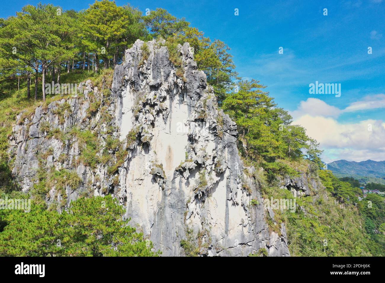 An imposing white rock surrounded by forest in Sagada, Philippines ...