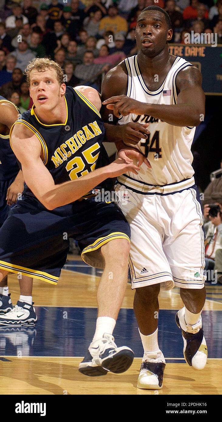 Notre Dame center Torin Francis (34) battles with Michigan forward ...