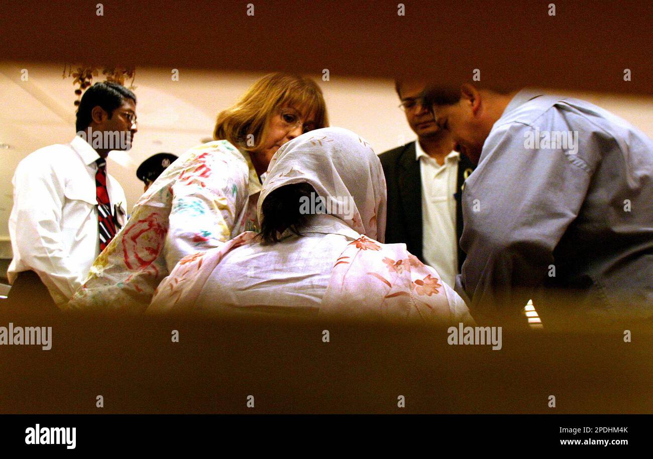 Elizabeth Lasry, second from left, and Singapore Airport officials ...