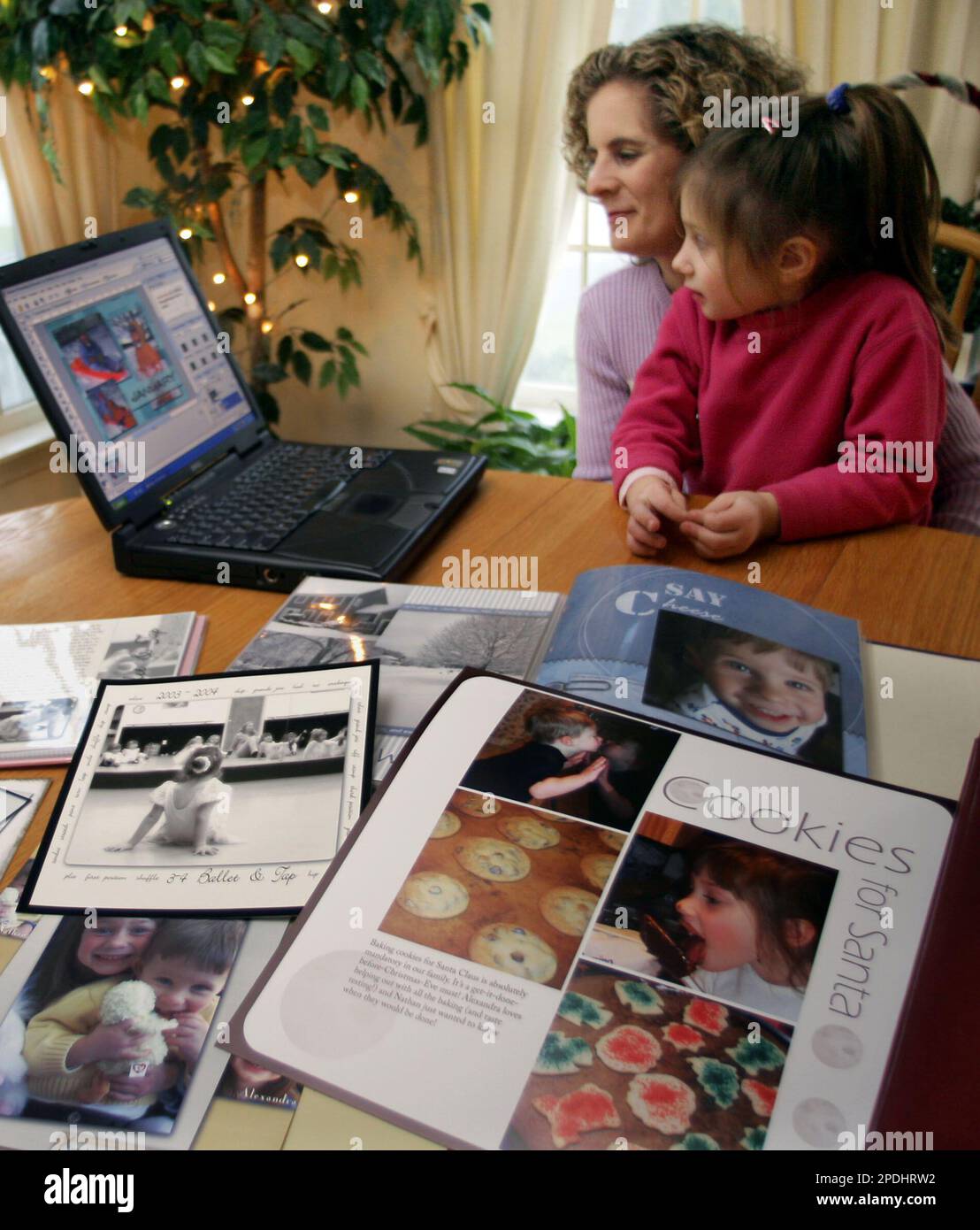 Tiffany Brand and her daughter Alexandra look at pictures on their ...