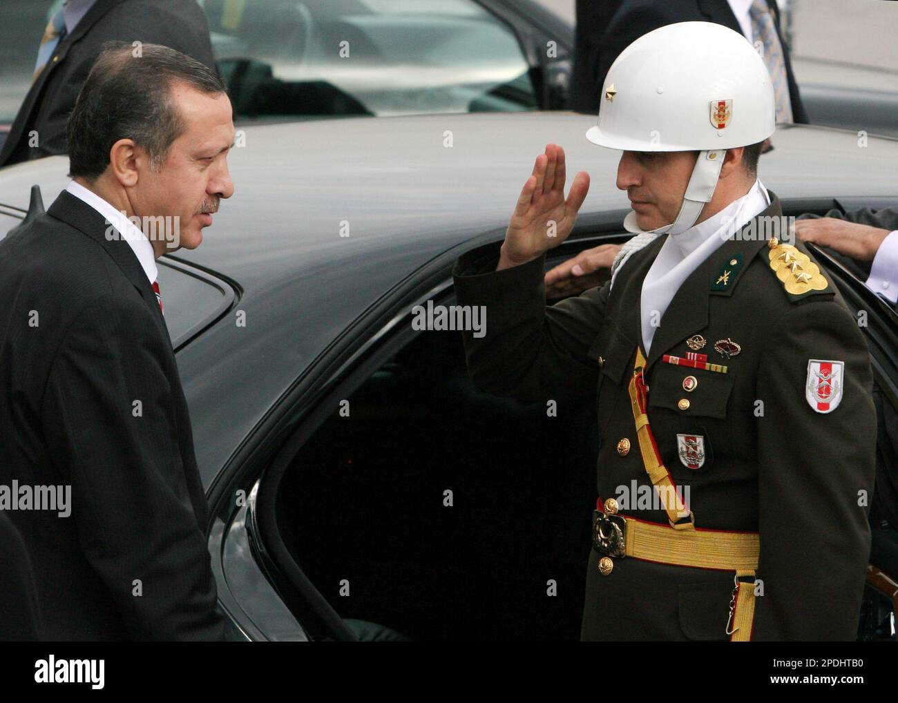 A Turkish army officer salutes Prime Minister Recep Tayyip Erdogan ...