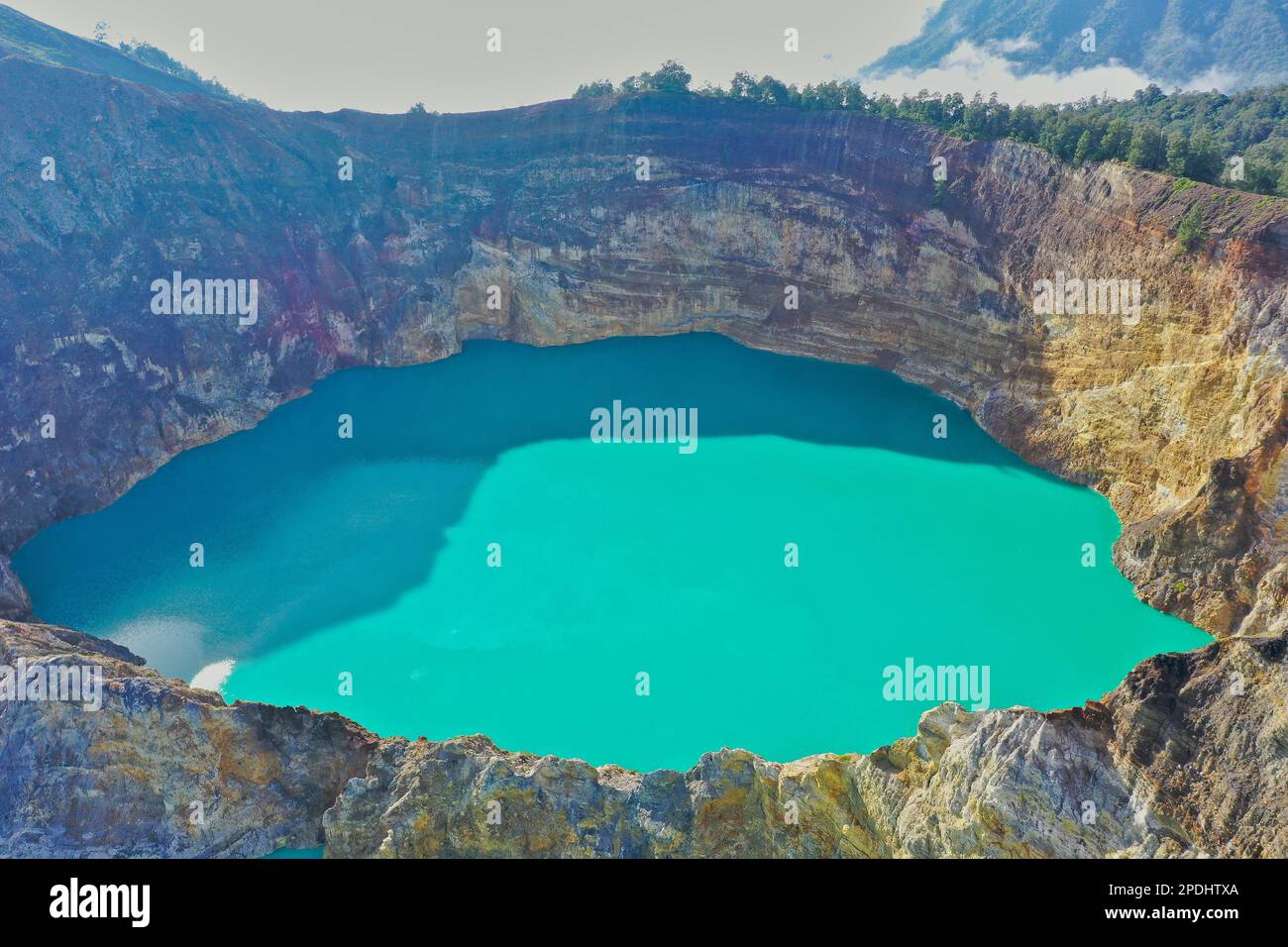 Panorama view of the sunlit turquoise crater lake of Mount Kelimutu ...