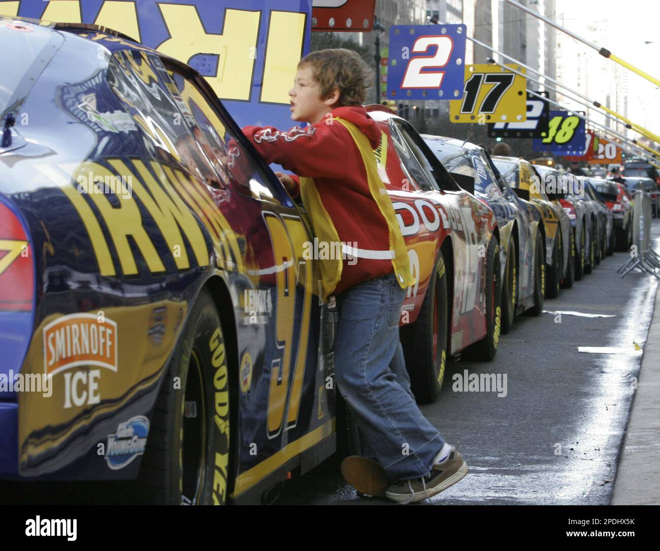 Collin Newell, 7, from Concord, N.C., leans against the number 97 car ...