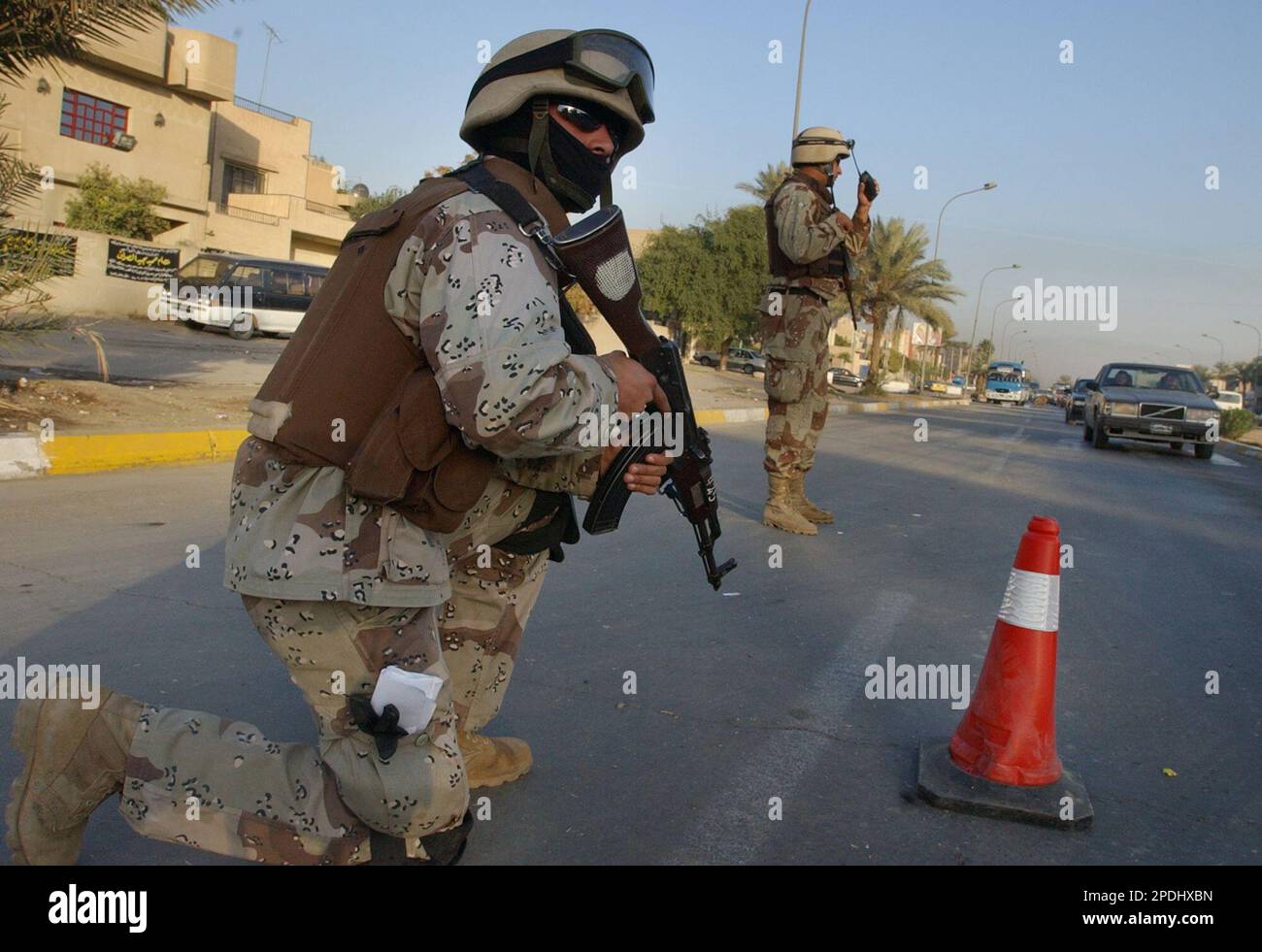 Two Iraqi soldiers take position by an army checkpoint in Baghdad, Iraq ...