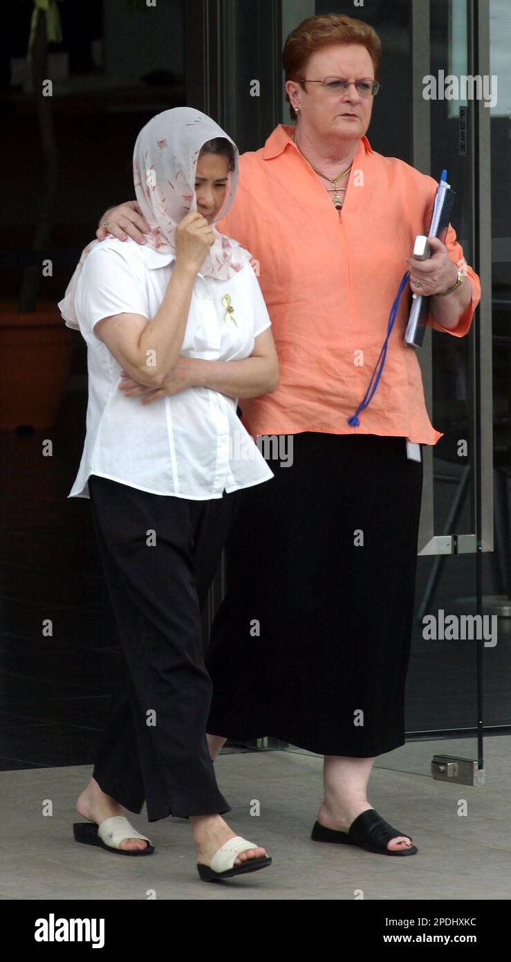 Kim Nguyen, left, walks with an Australian High Commission official as ...