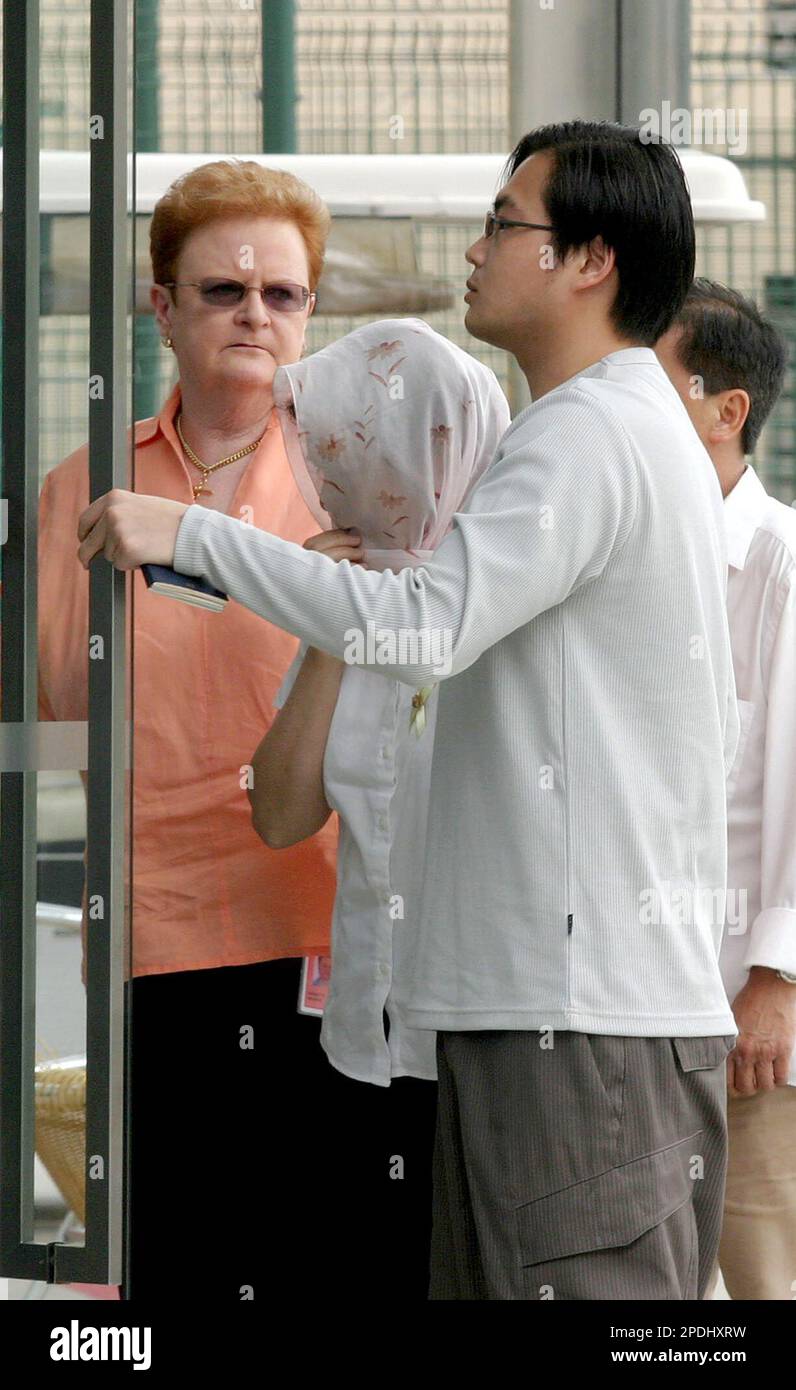 Kim Nguyen, center, walks with her son, Khoa Nguyen, right, and an ...