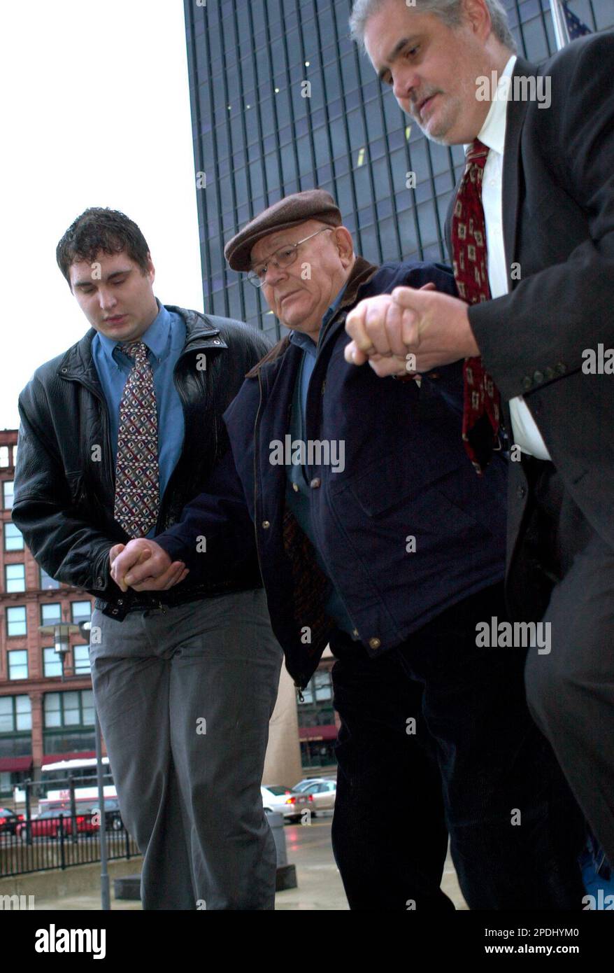 Accused Nazi death camp guard John Demjanjuk, center, is helped into ...